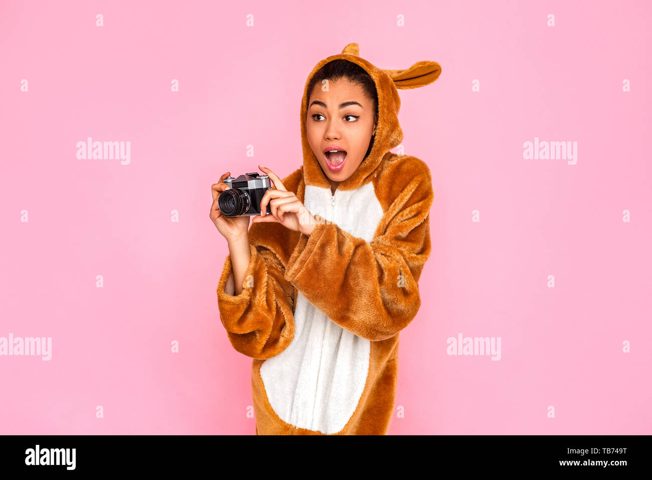 Young Woman In Bunny Kigurumi Standing Isolated On Pink Background