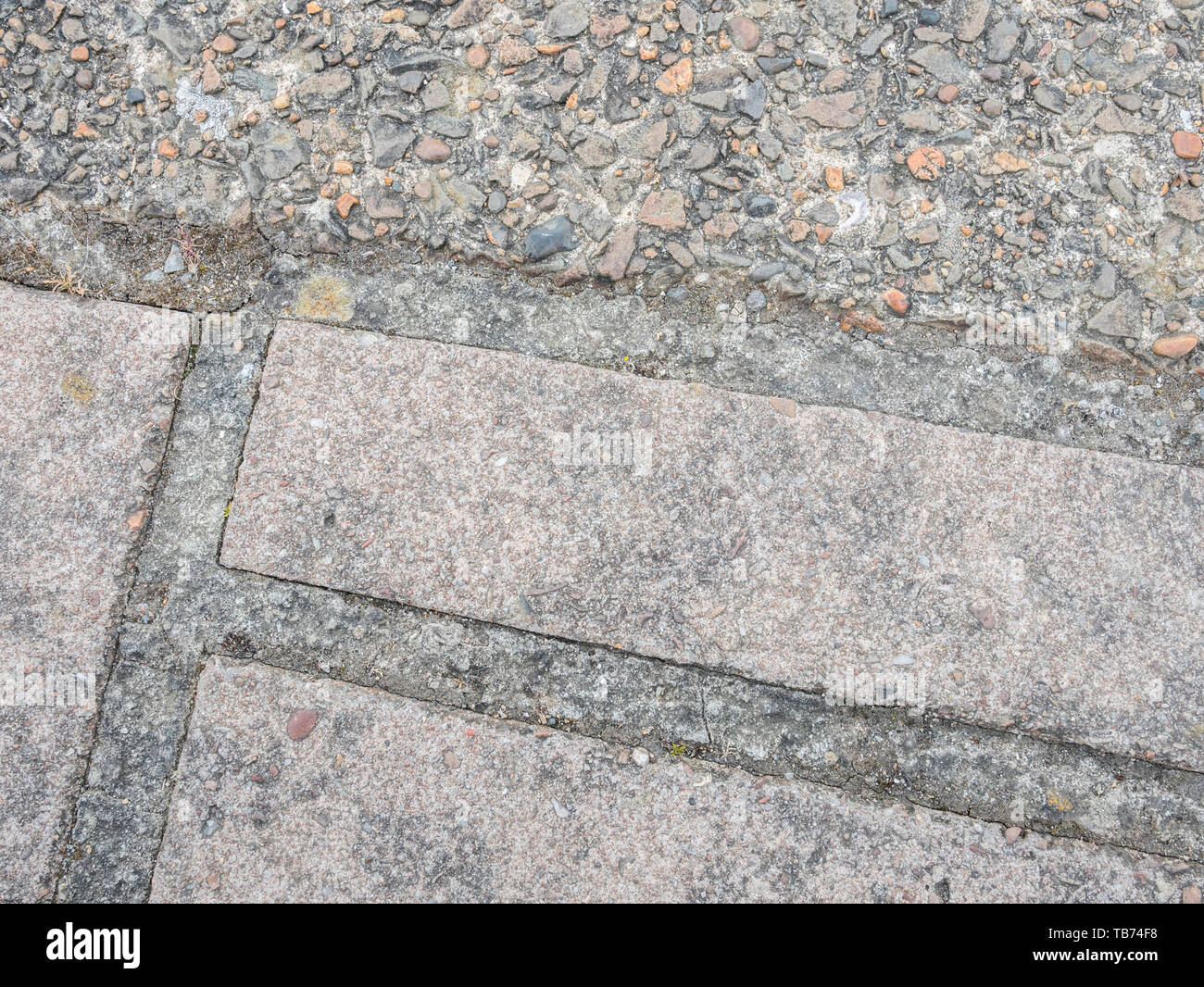 Badly fitting section of concrete paving. Metaphor 'a bad fit', gap ...