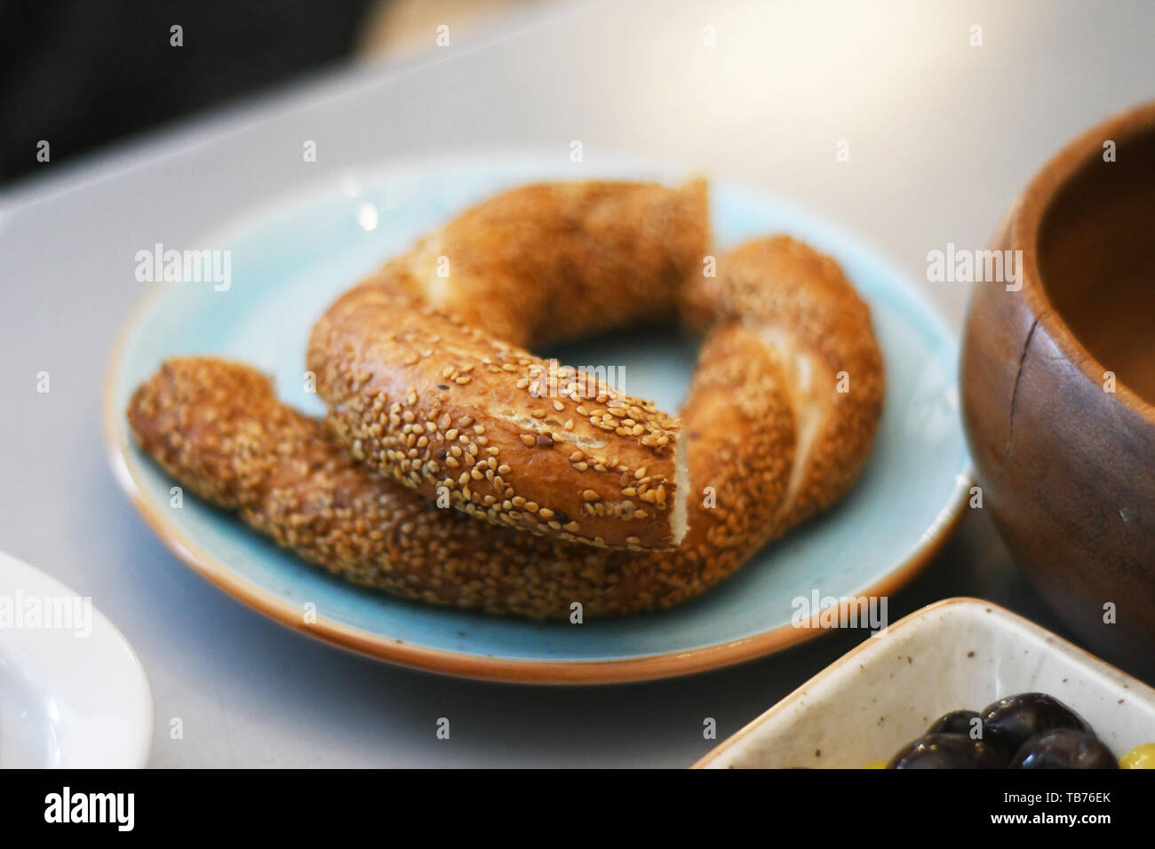 Turkish simit cut on a plate closeup Stock Photo - Alamy