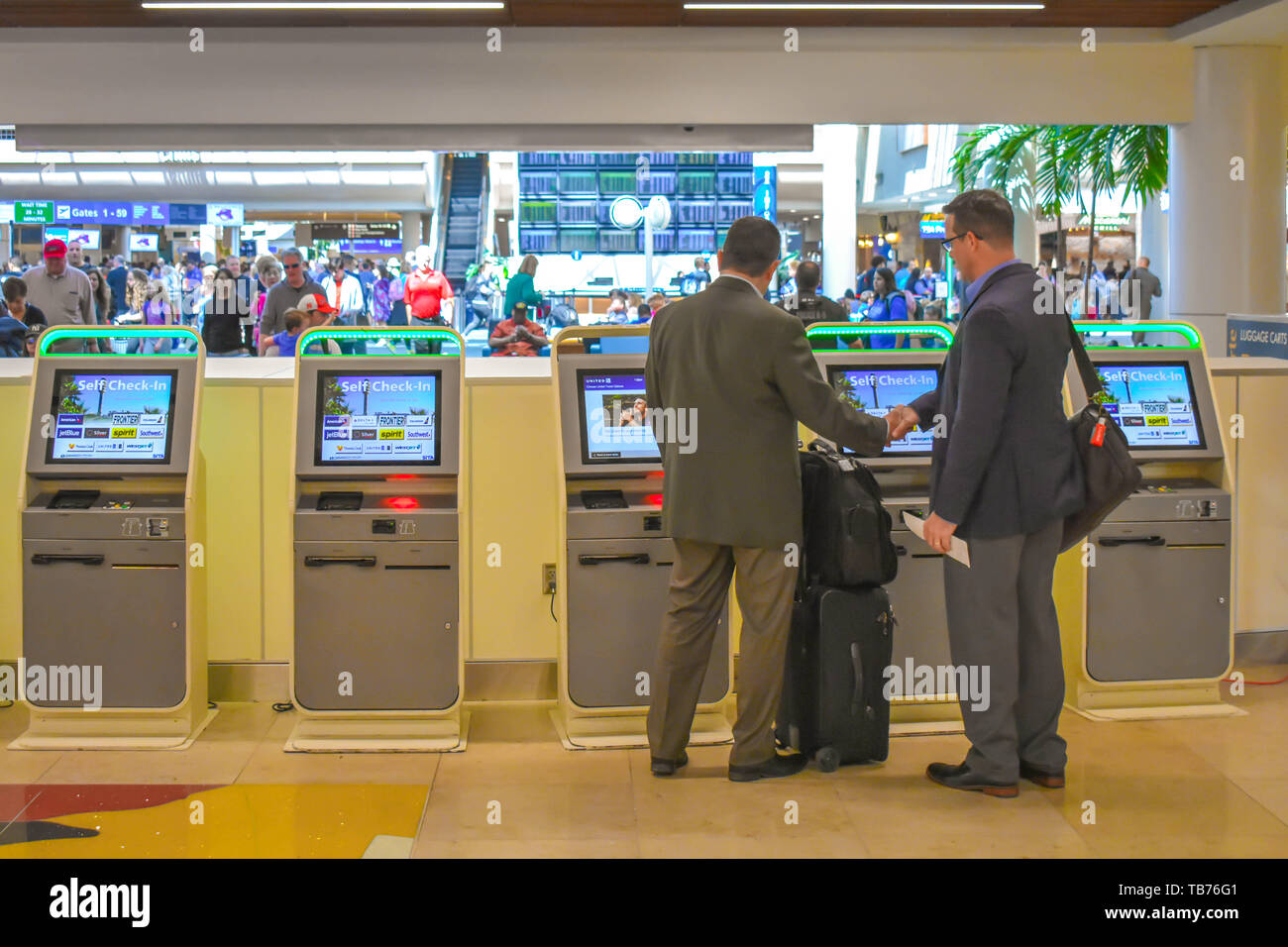 Orlando, Florida. March 01, 2019. Businessman using Self service check ...