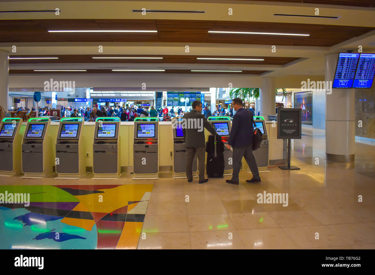 Orlando, Florida. March 01, 2019. Businessman using Self service check ...
