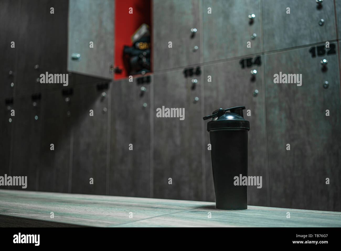 black protein shaker on pile of weight plates isolated on black Stock ...