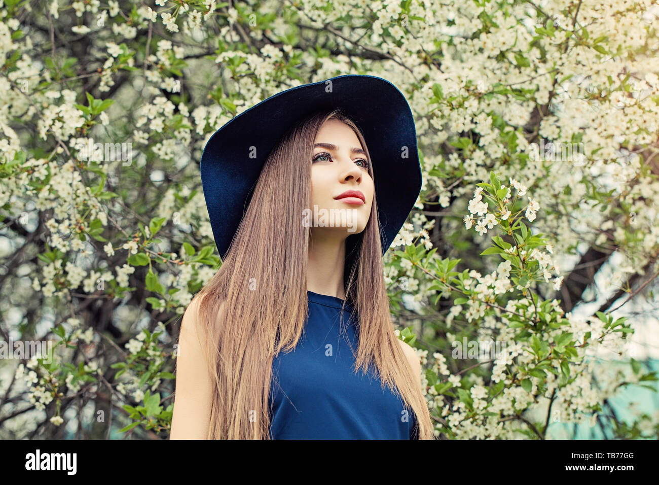 Pretty young woman in blue hat outdoors Stock Photo - Alamy
