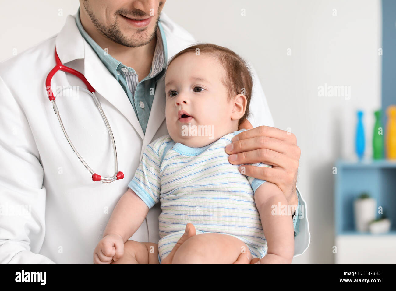 Pediatrician with cute little baby in clinic Stock Photo - Alamy