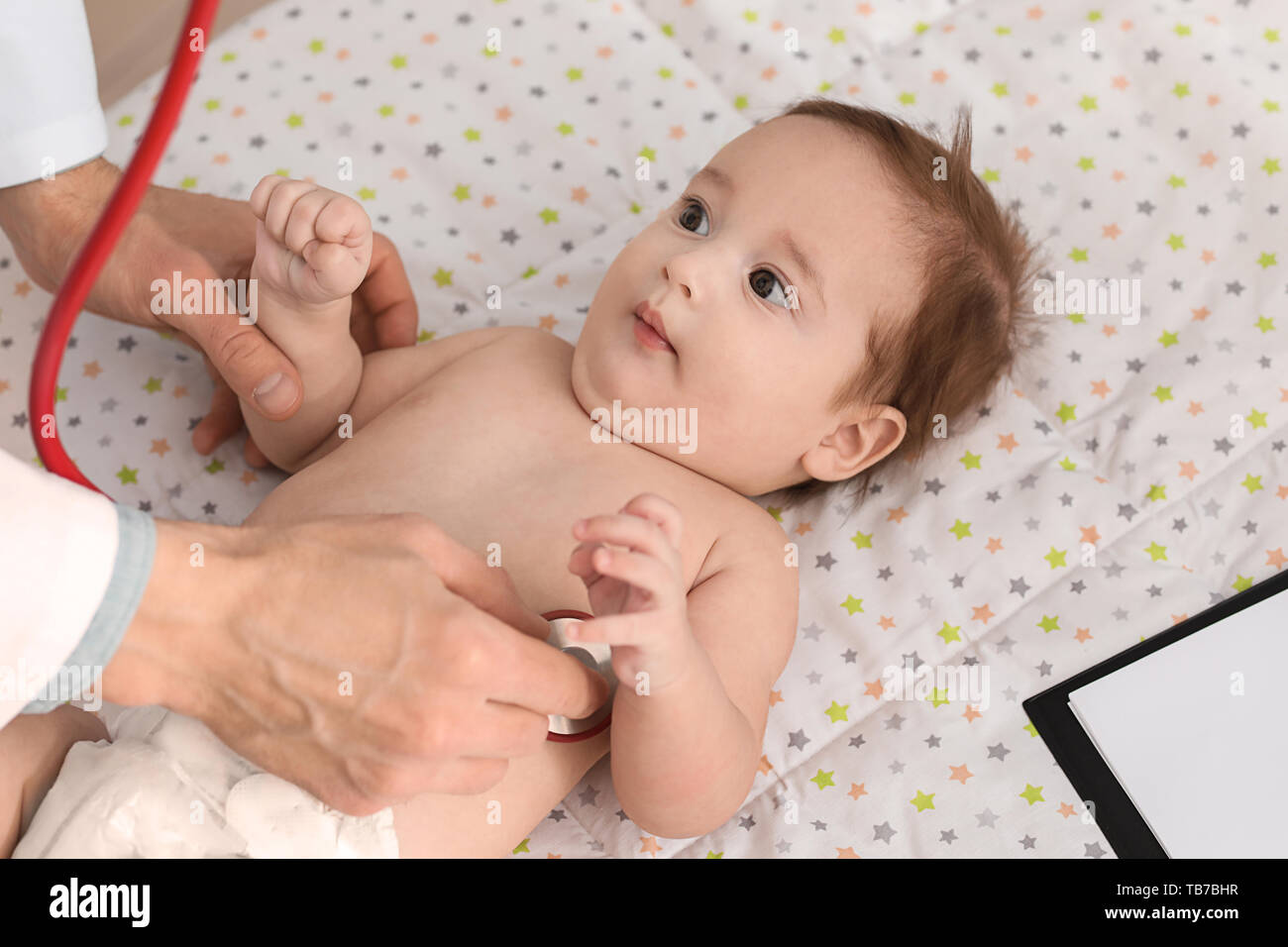 Pediatrician examining little baby in clinic Stock Photo - Alamy