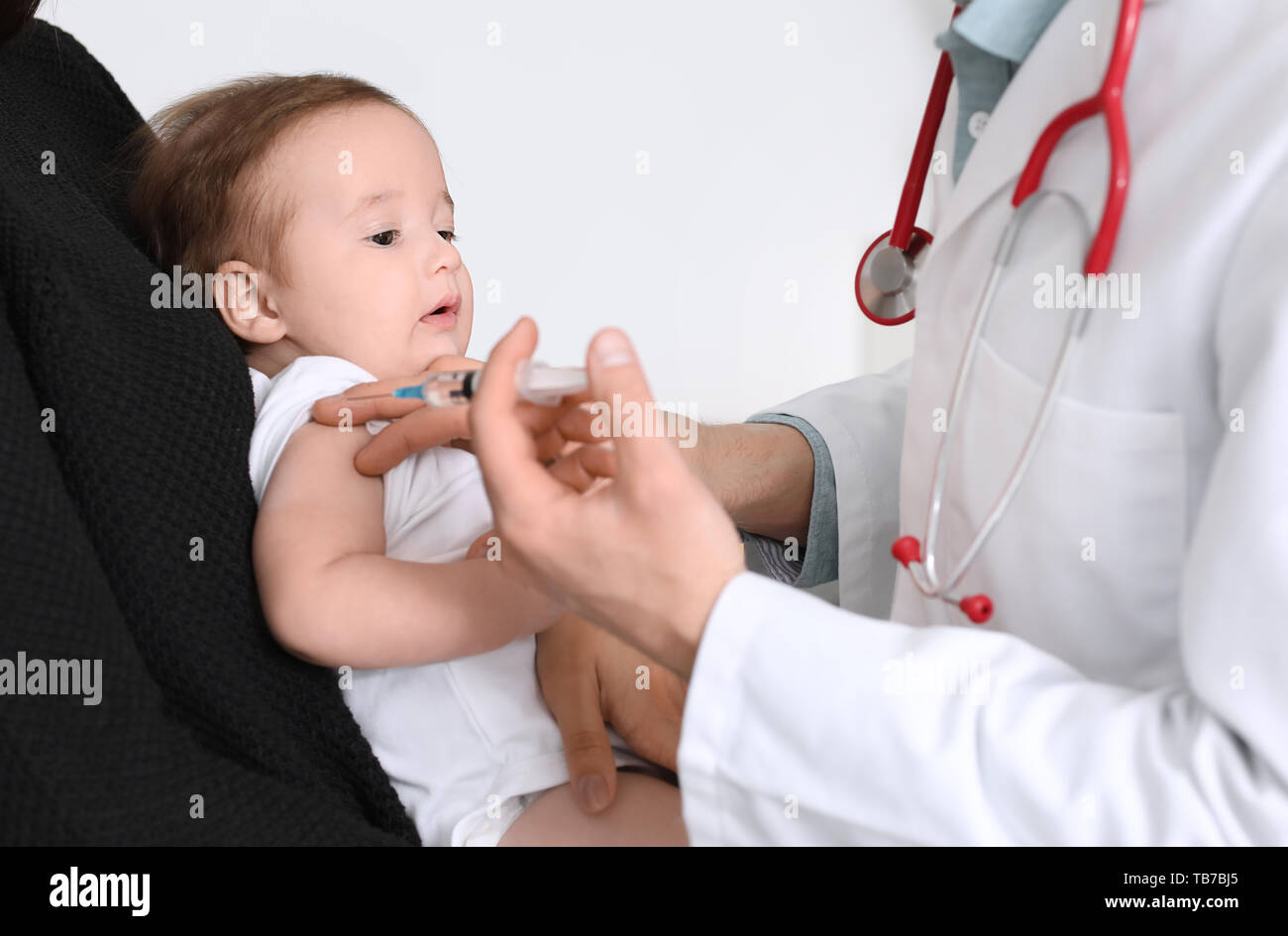 Pediatrician giving little baby an injection in clinic Stock Photo - Alamy