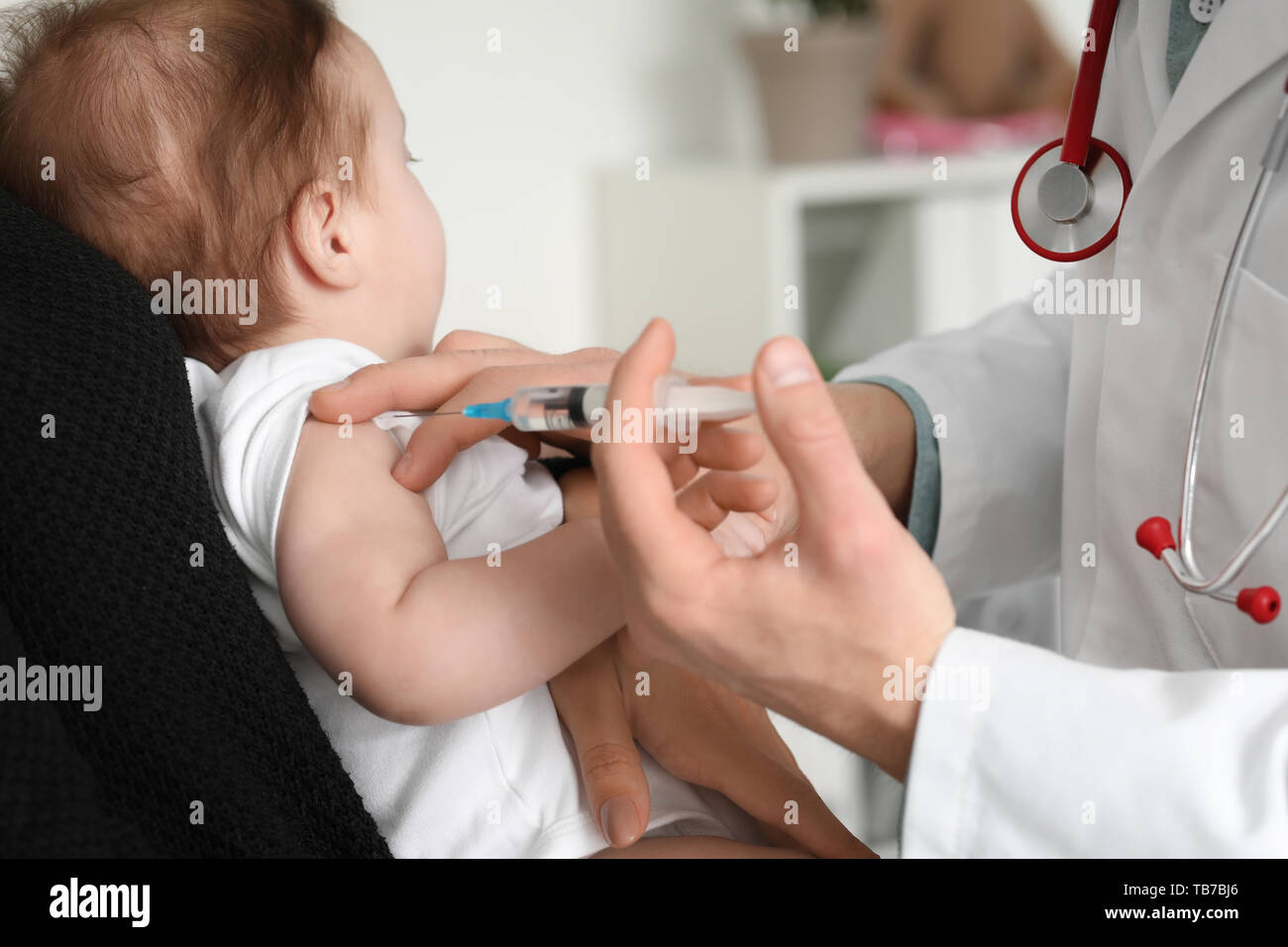 Pediatrician giving little baby an injection in clinic Stock Photo - Alamy