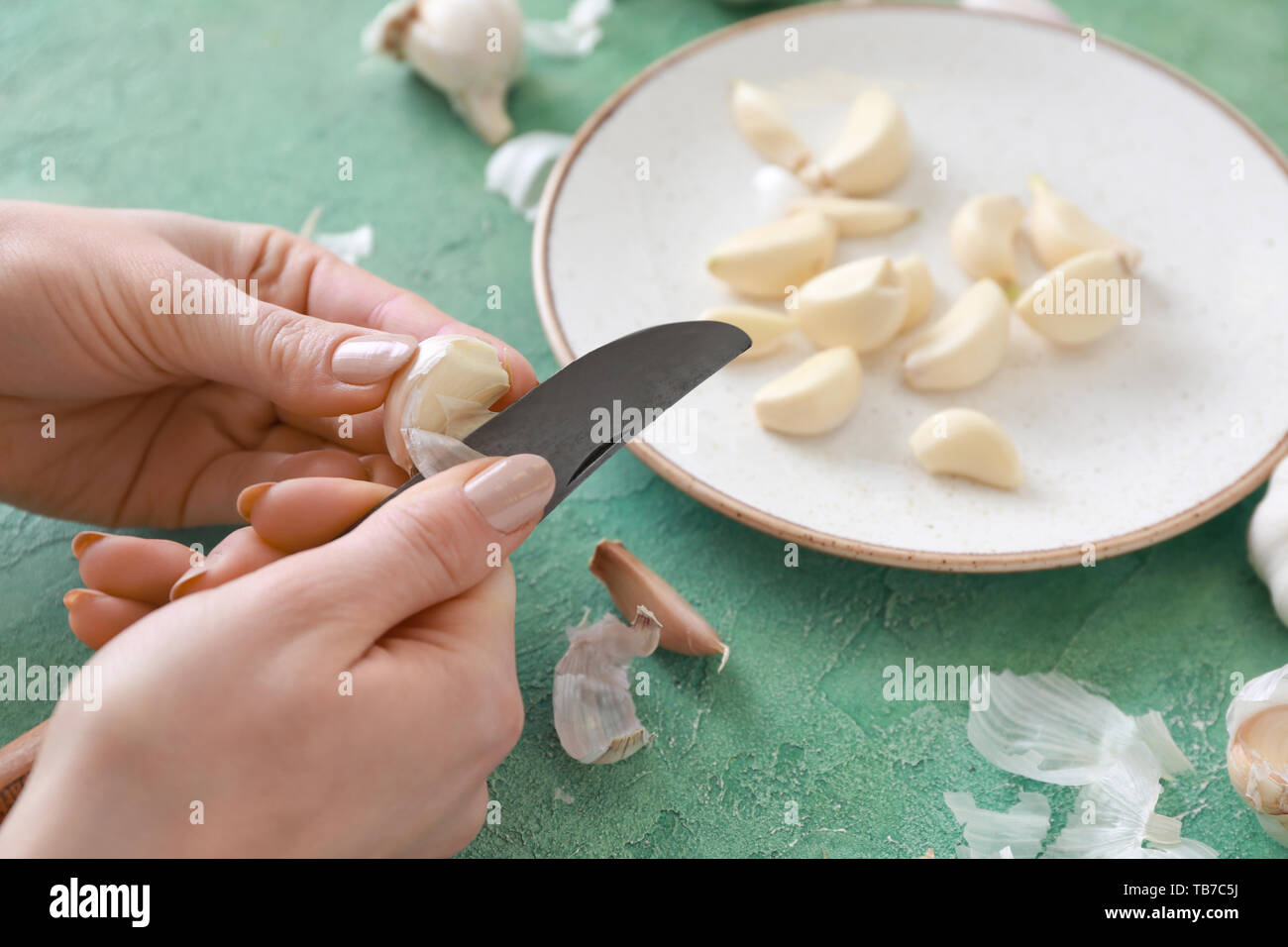 Woman peeling garlic hands knife hi-res stock photography and images ...
