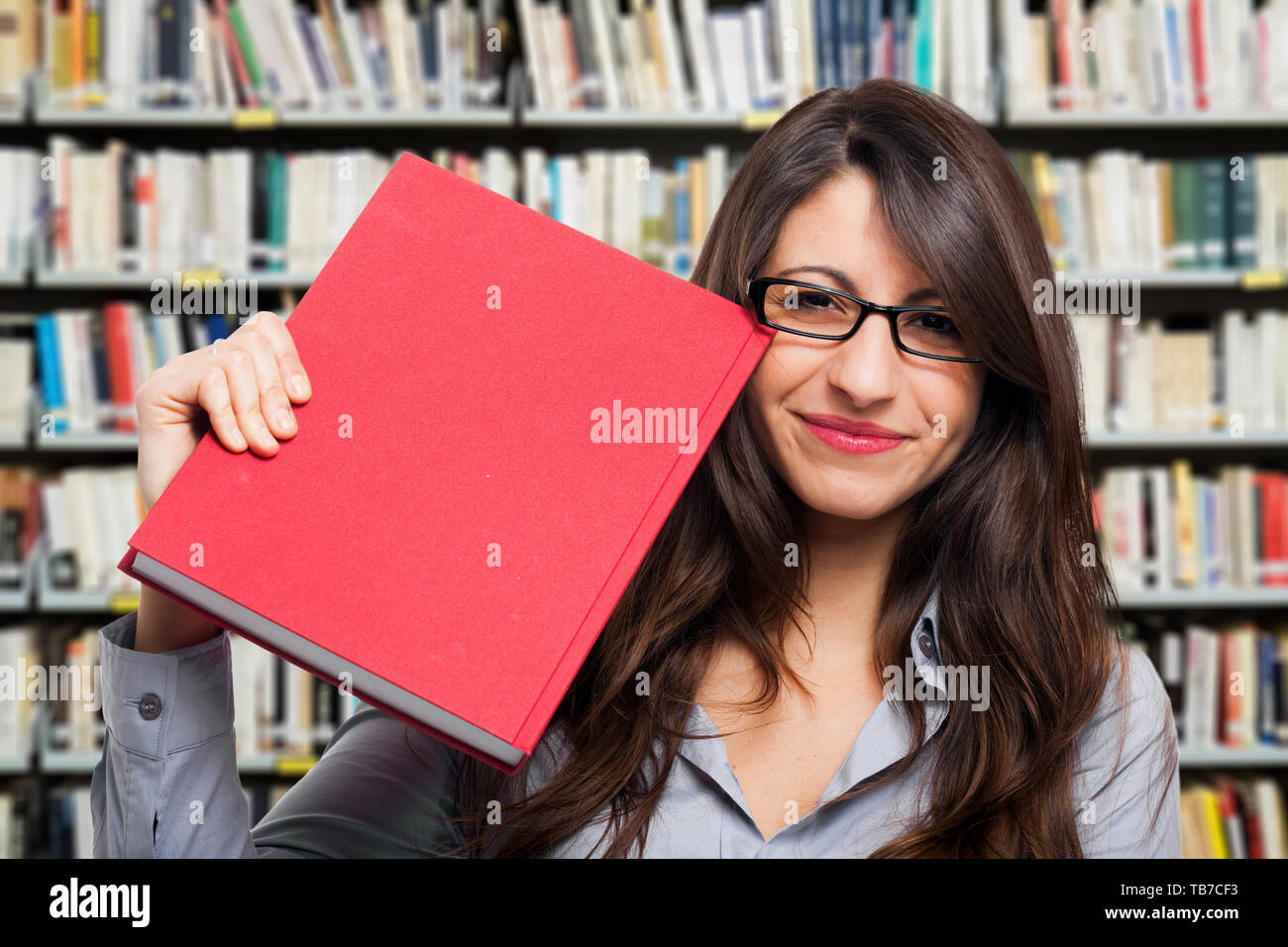 Portrait of a woman in a library Stock Photo - Alamy