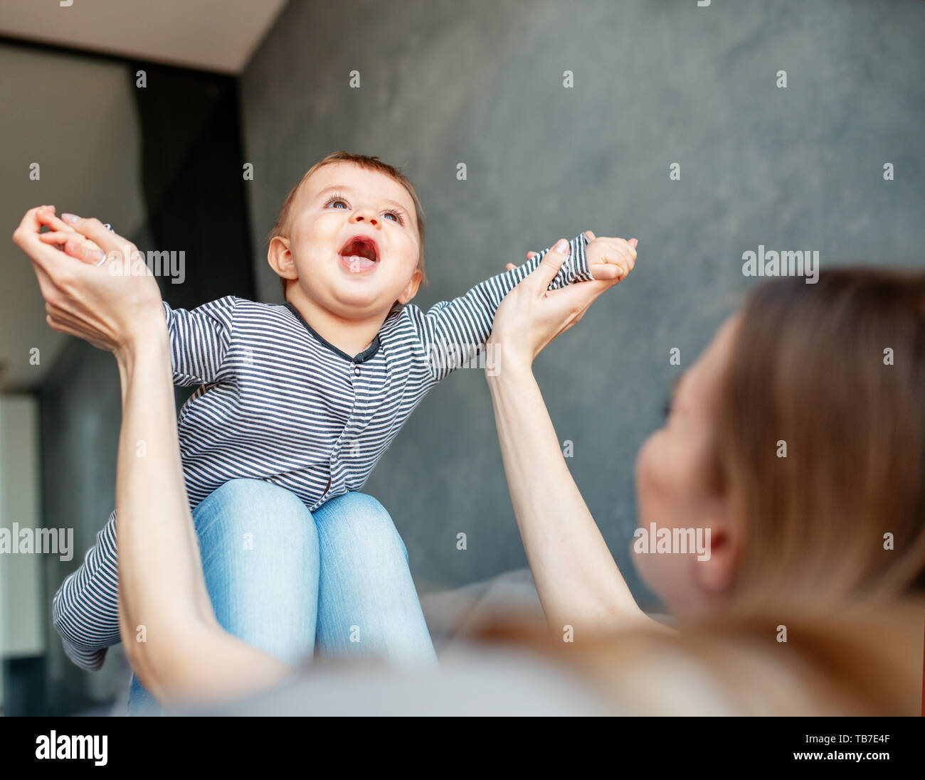 Little child smiling and happy with mom Stock Photo - Alamy