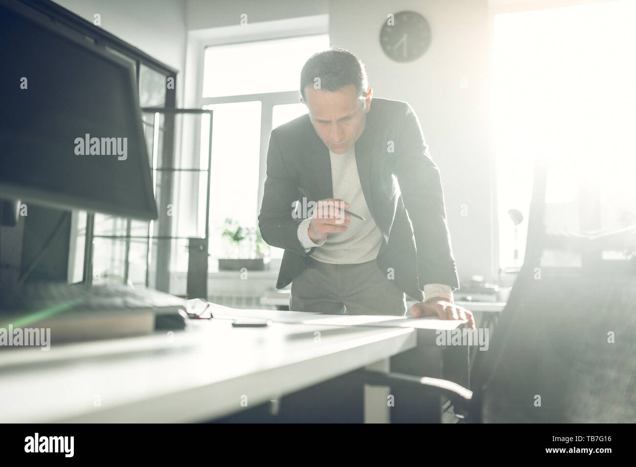 Mature businessman feeling busy while working in the office Stock Photo ...