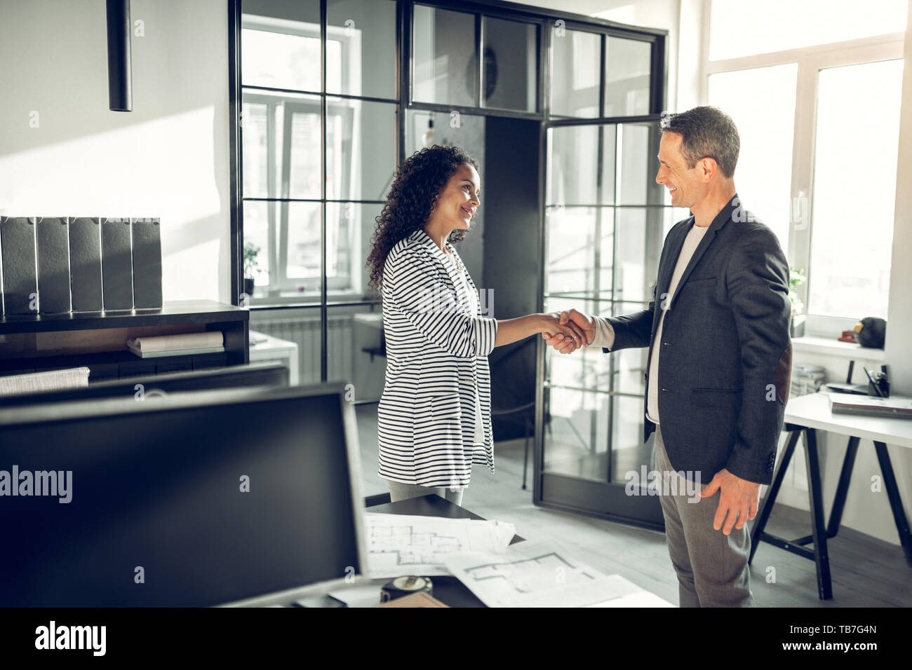 Assistant shaking hand of her boss after successful cooperation Stock ...