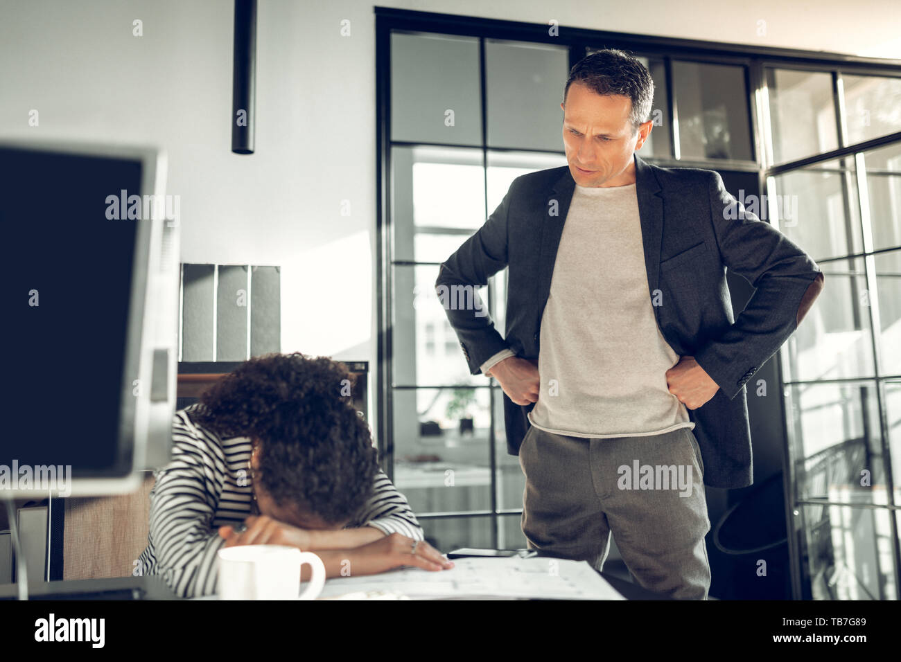 Angry boss standing and talking to his secretary sleeping Stock Photo ...