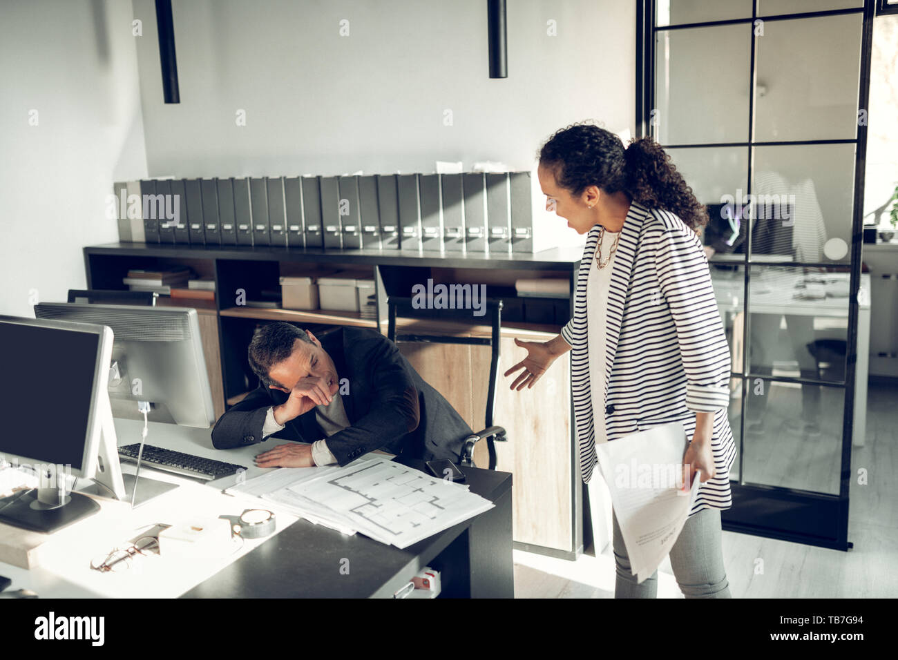 Businesswoman yelling at her employee sleeping at work Stock Photo - Alamy