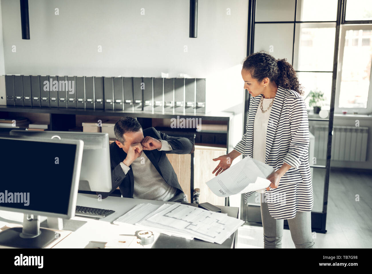 Female boss seeing her employee sleeping at workplace Stock Photo - Alamy