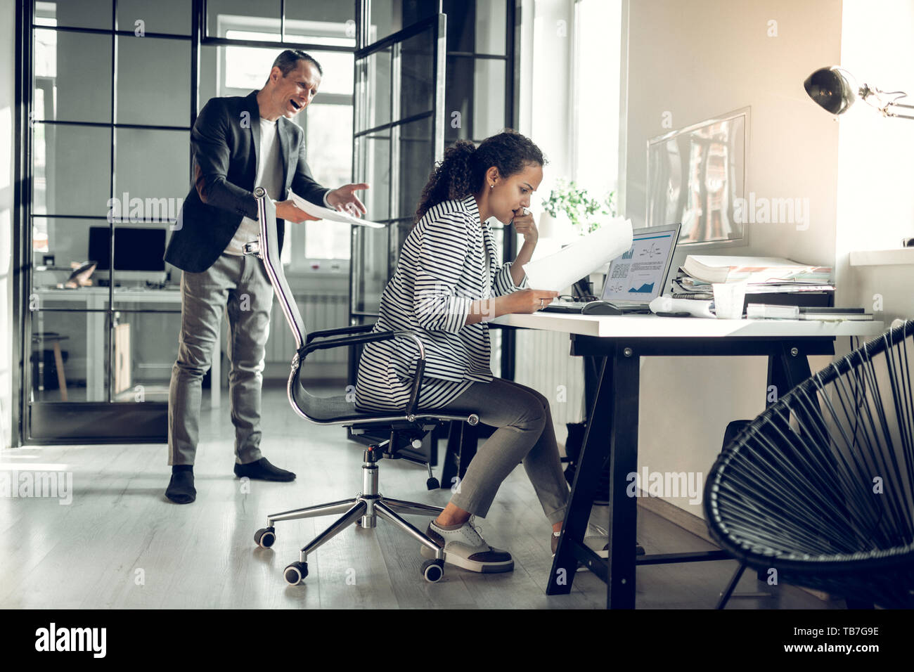 Angry boss shouting at his young trainee for not completing task Stock ...