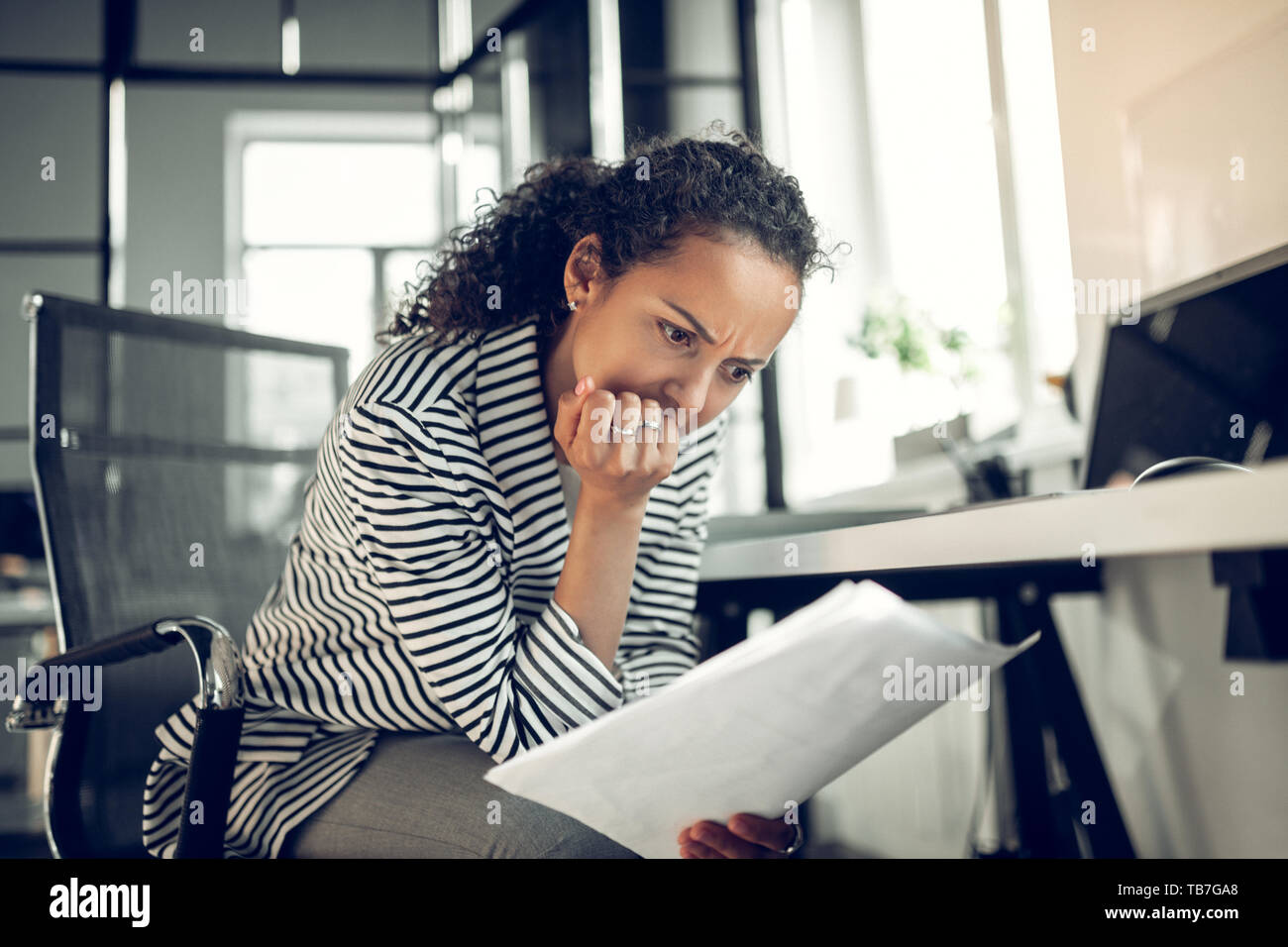 Trainee feeling busy and involved in reading documents Stock Photo - Alamy