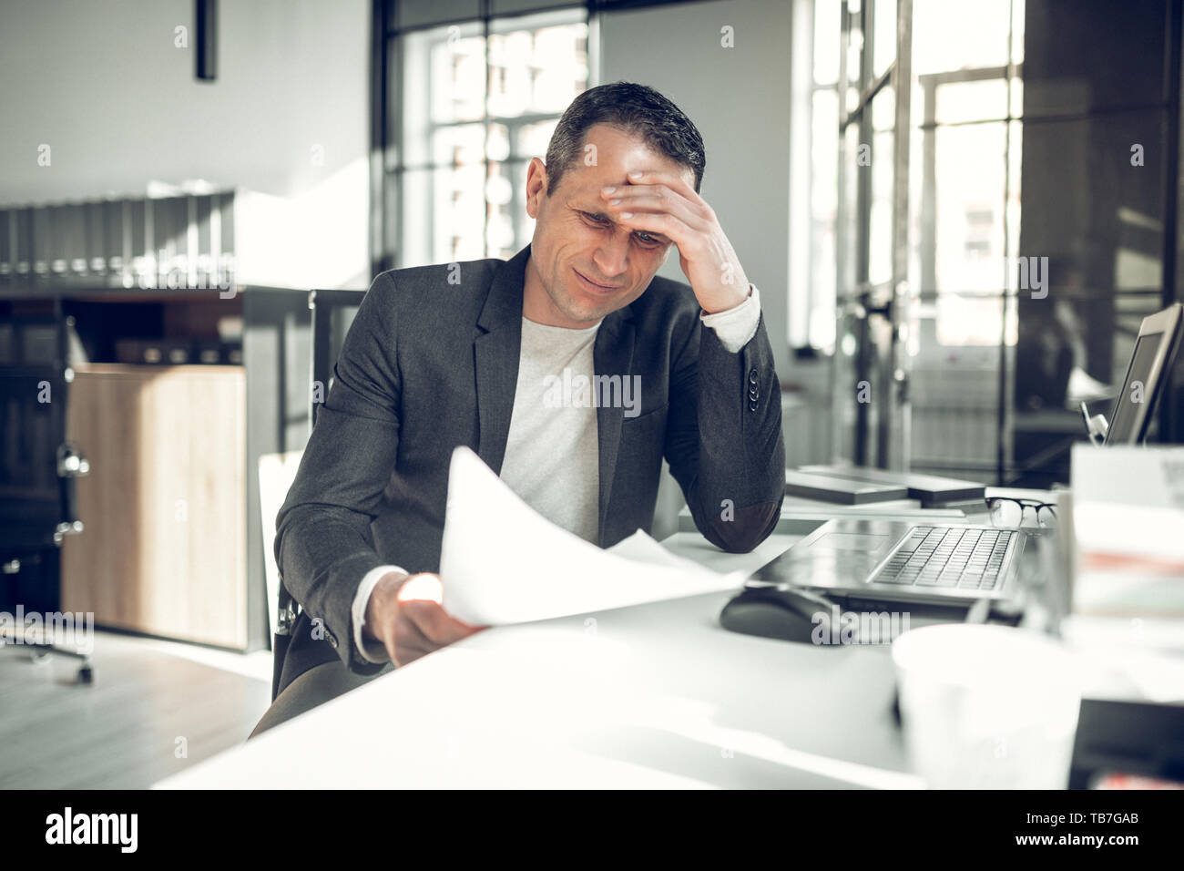 Businessman having too many complications working on report Stock Photo ...