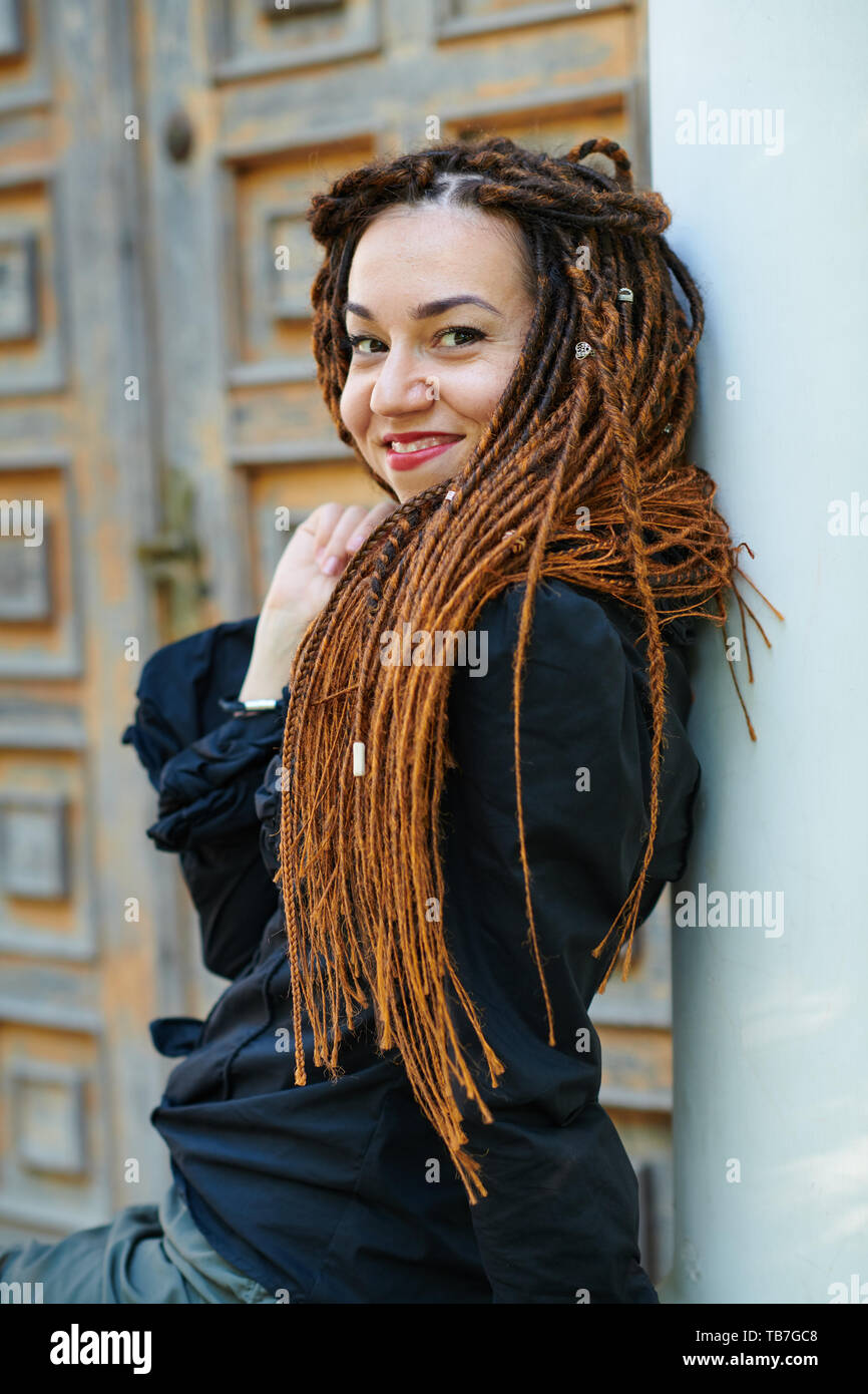 dreadlocks fashionable girl posing at old wooden door background Stock ...