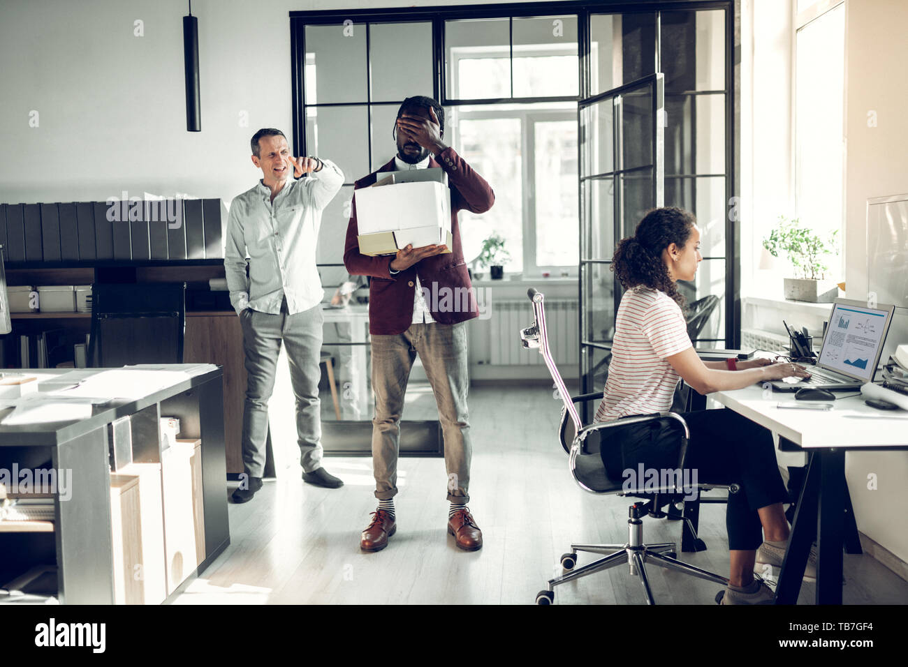Boss firing inexperienced assistant from his office Stock Photo - Alamy