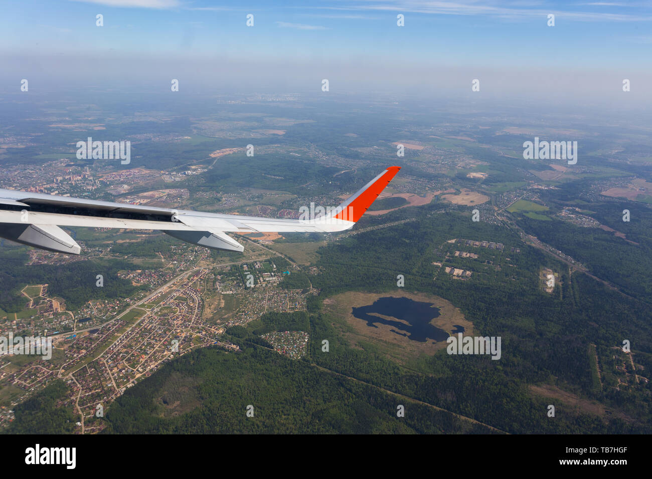 Aerial view of cloud blue sky and plane wing view through the airplane ...
