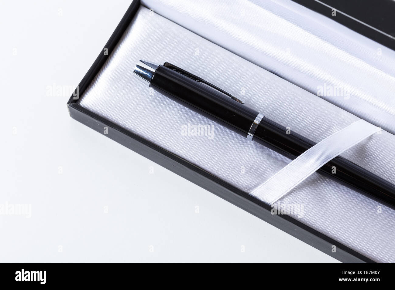 Pen in box on white background Stock Photo - Alamy