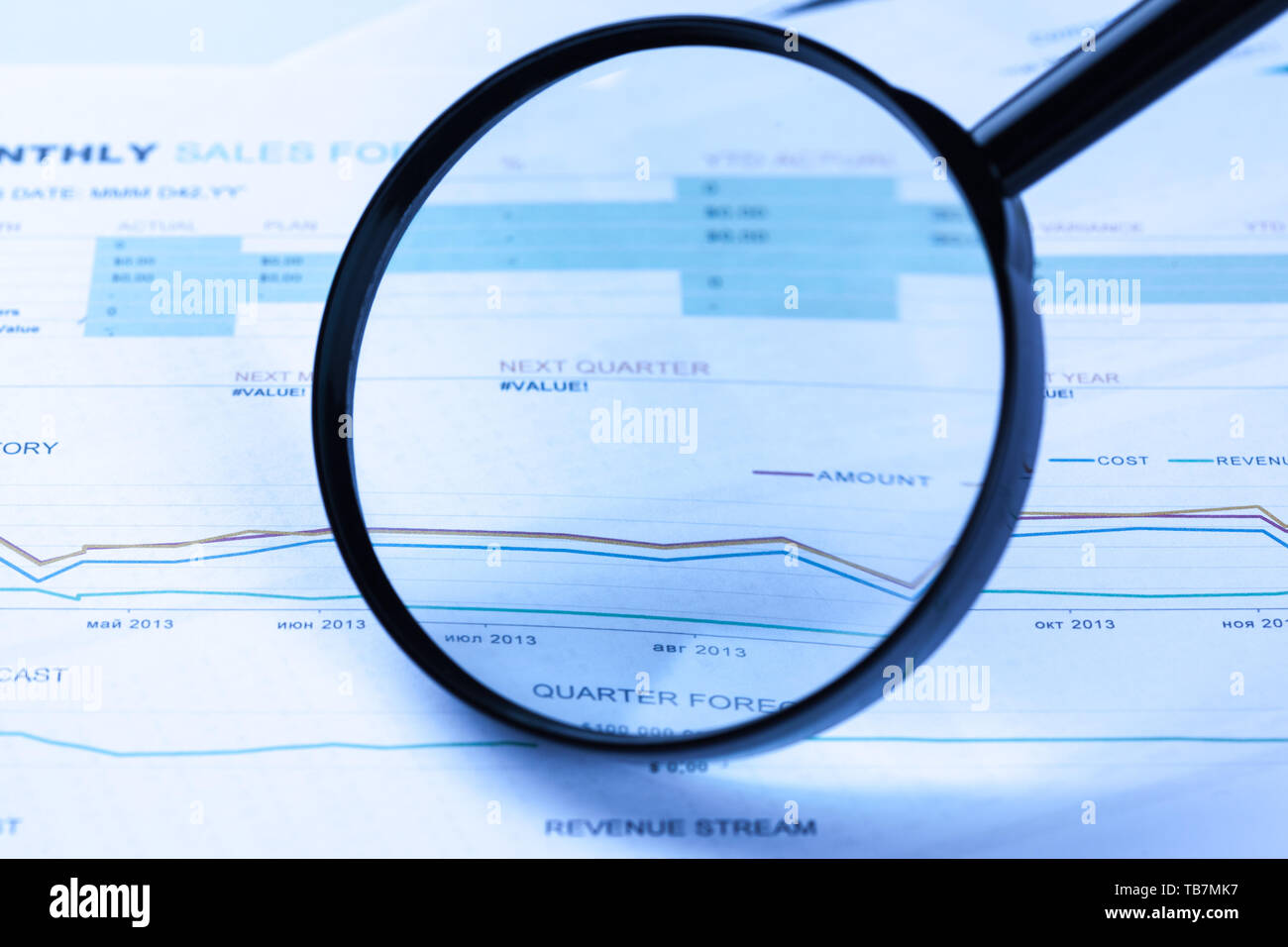 Magnifying glass over financial graph hi-res stock photography and ...