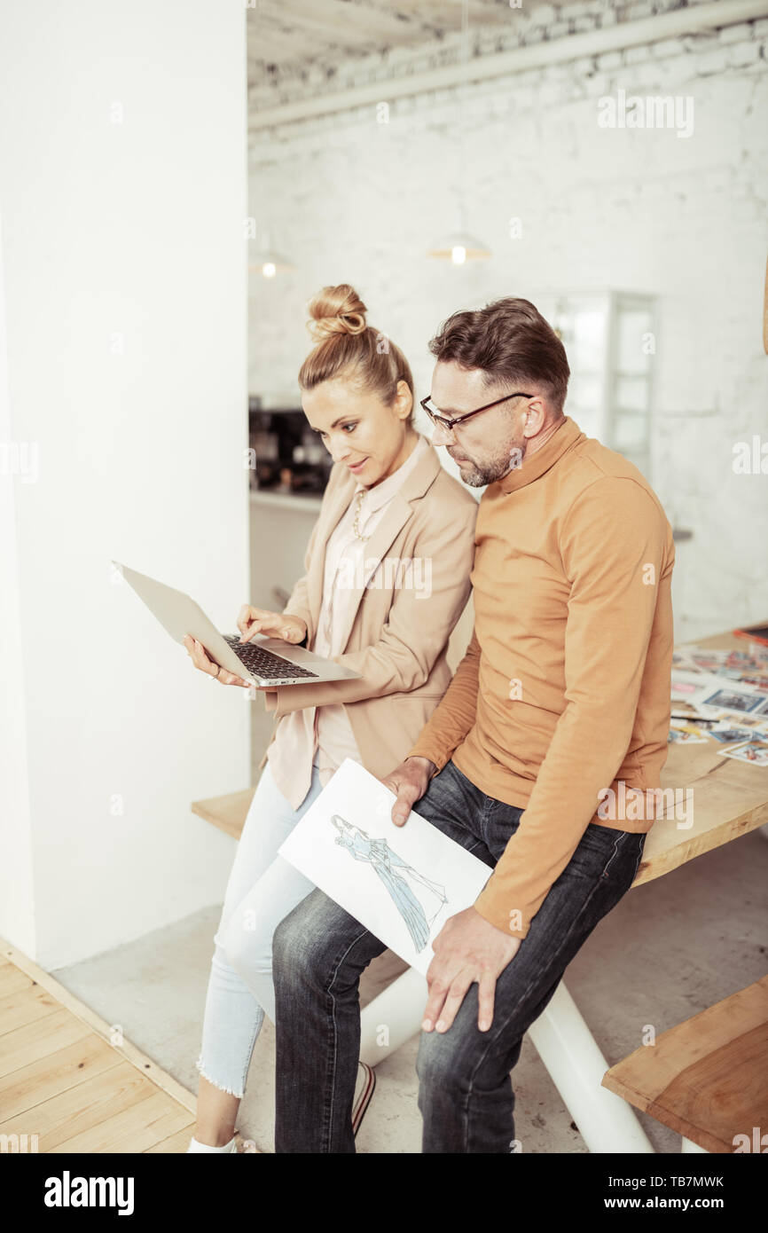 Searching ideas. Fashion designer working on his new collection with ...