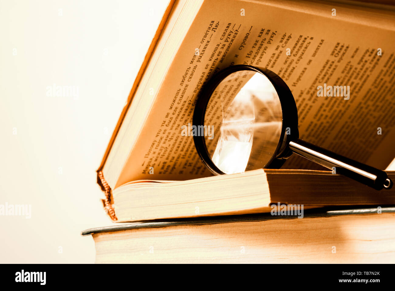 books and magnifying glass Stock Photo - Alamy