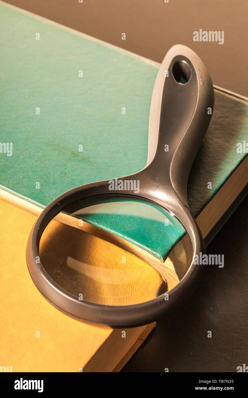 books and magnifying glass Stock Photo - Alamy