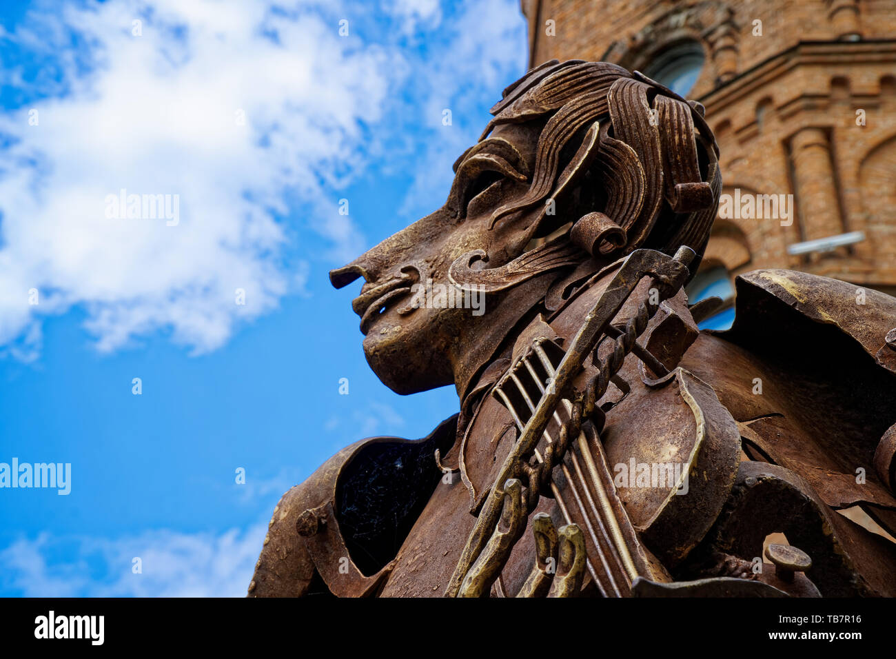 Face of an old rusty statue with iron violin Stock Photo - Alamy