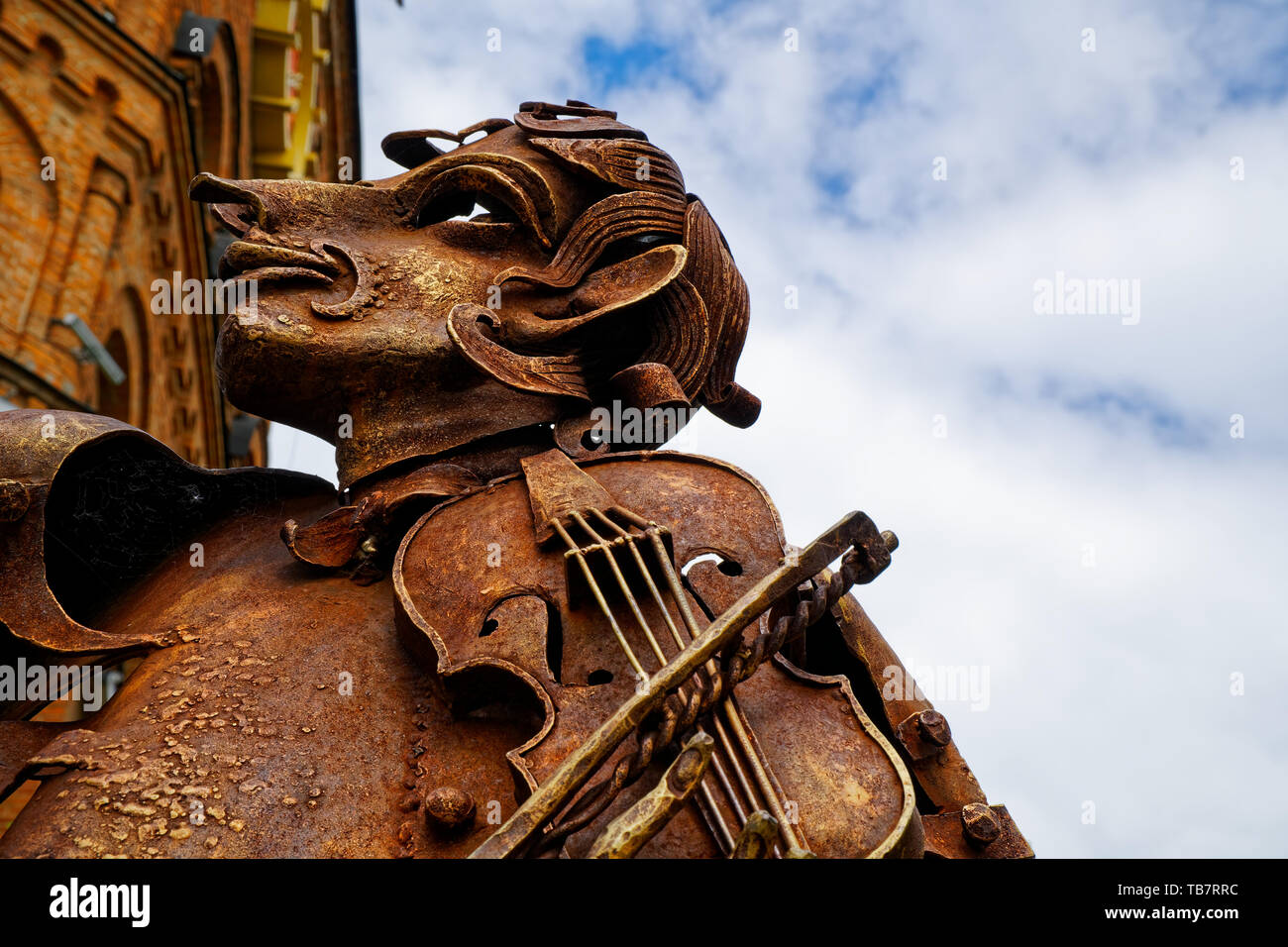 Face of an old rusty statue with iron violin Stock Photo - Alamy