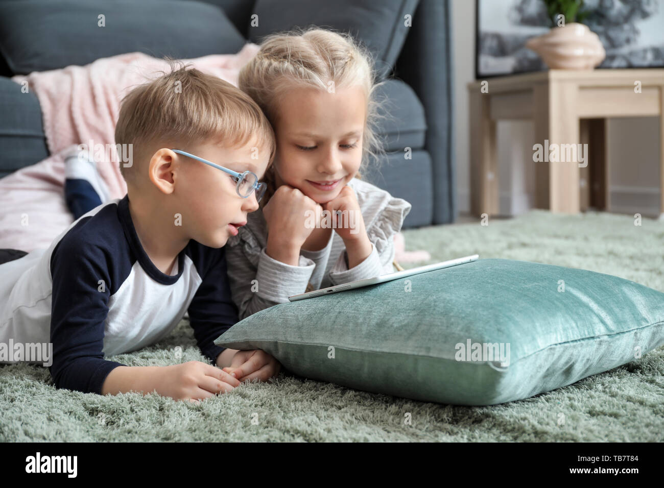 Cute little children watching cartoons at home Stock Photo - Alamy
