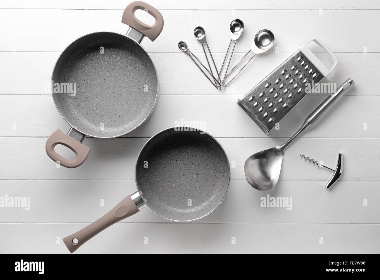 Set of kitchen utensils on white wooden background Stock Photo - Alamy