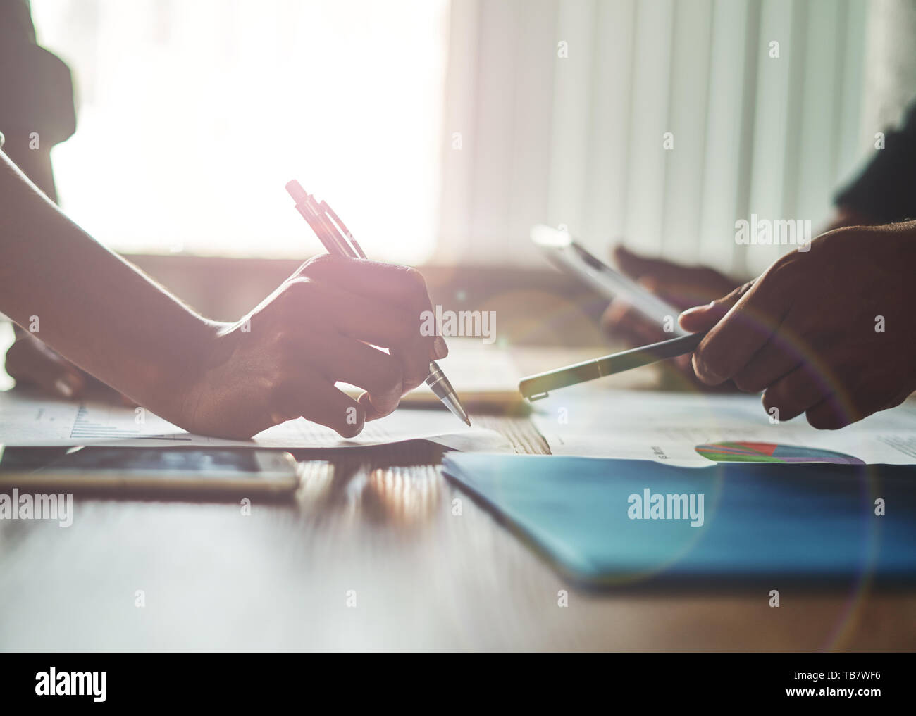 Close-up of business people's hand holding pen at workplace Stock Photo ...