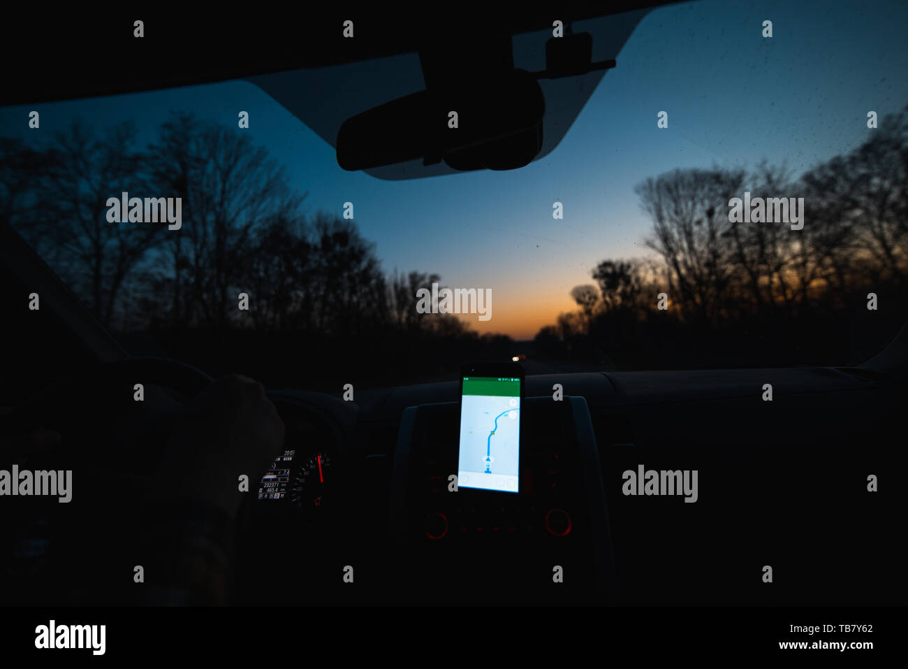 view from inside of car navigation on phone. sunrise. car travel ...