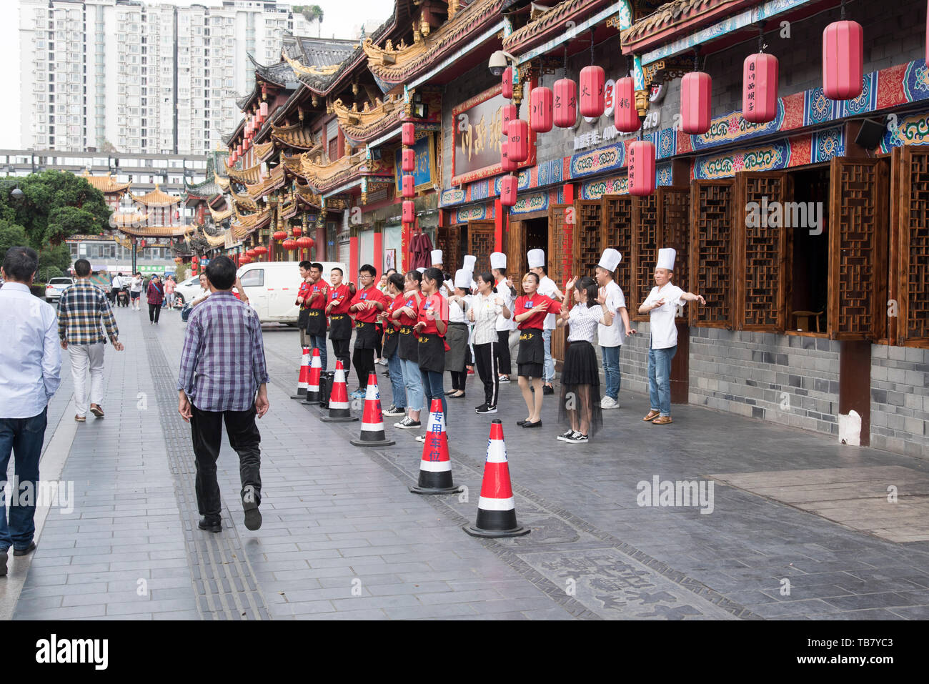 Uniformed Restaurant staff wait outside for customers. Chengdu, Kuan ...
