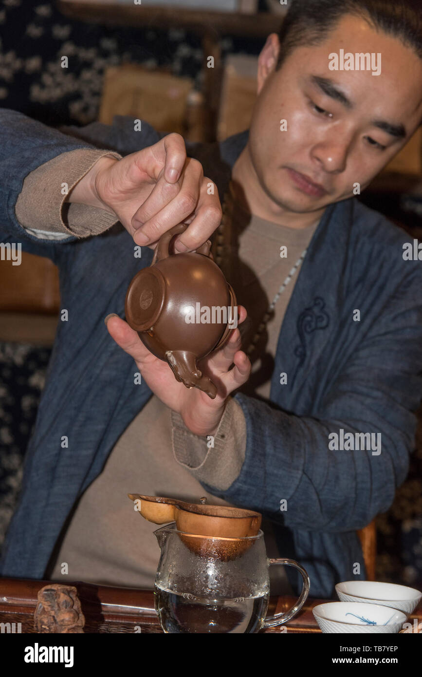 Chinese Tea Ceremony. Male server prepares the traditional tea ...