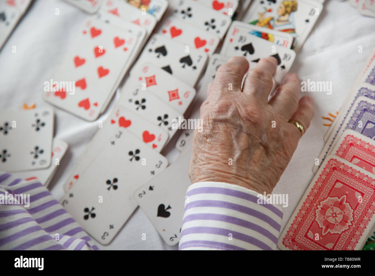Very old senior lady playing cards alone at home Stock Photo - Alamy