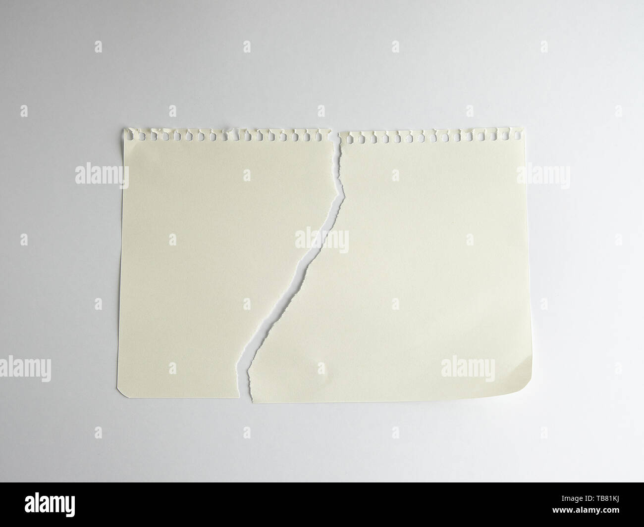 sheet of white paper torn in half with a spiral notepad, close up Stock ...