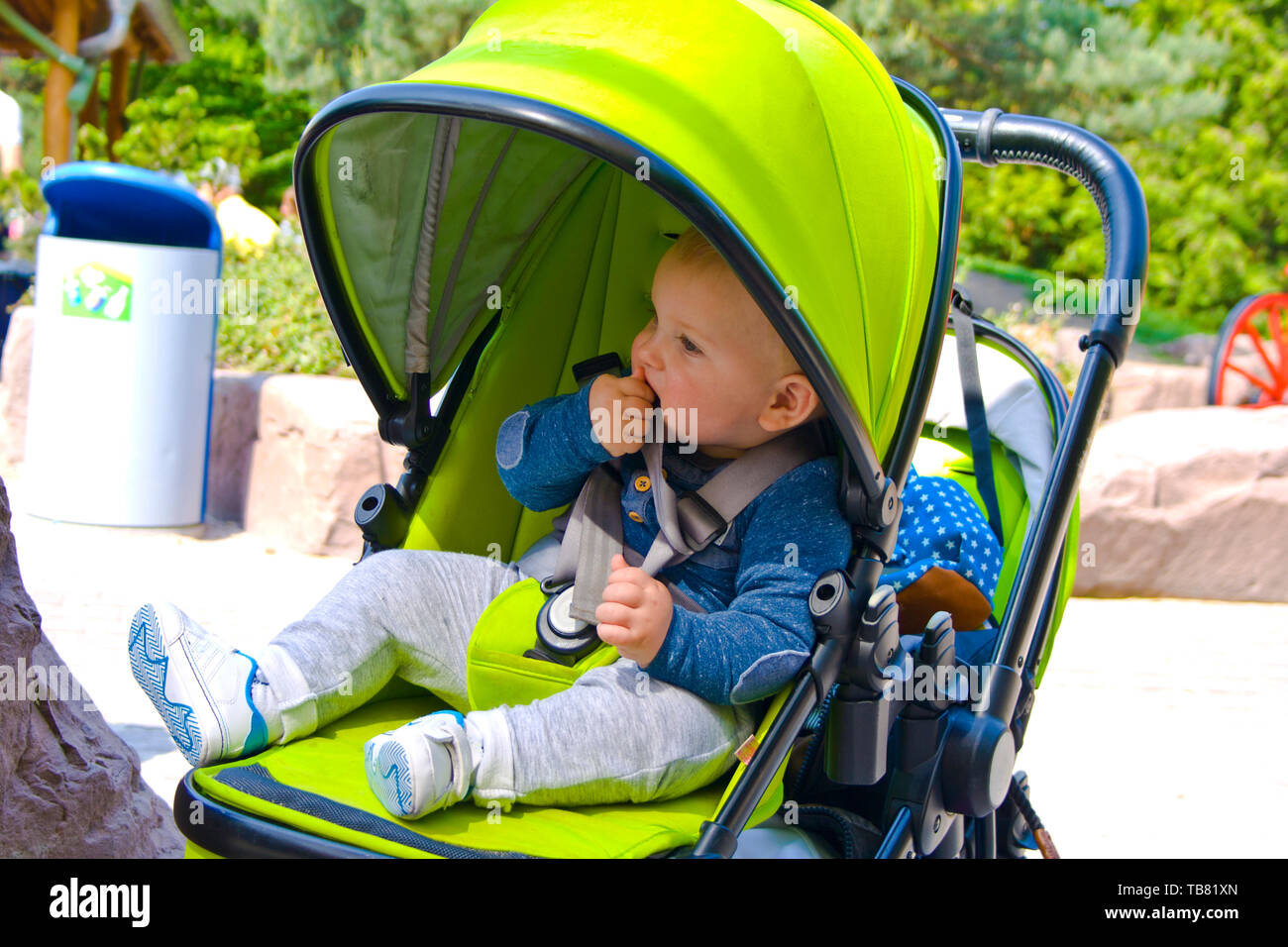 Little boy is sitting in pram with a smiling face Stock Photo - Alamy