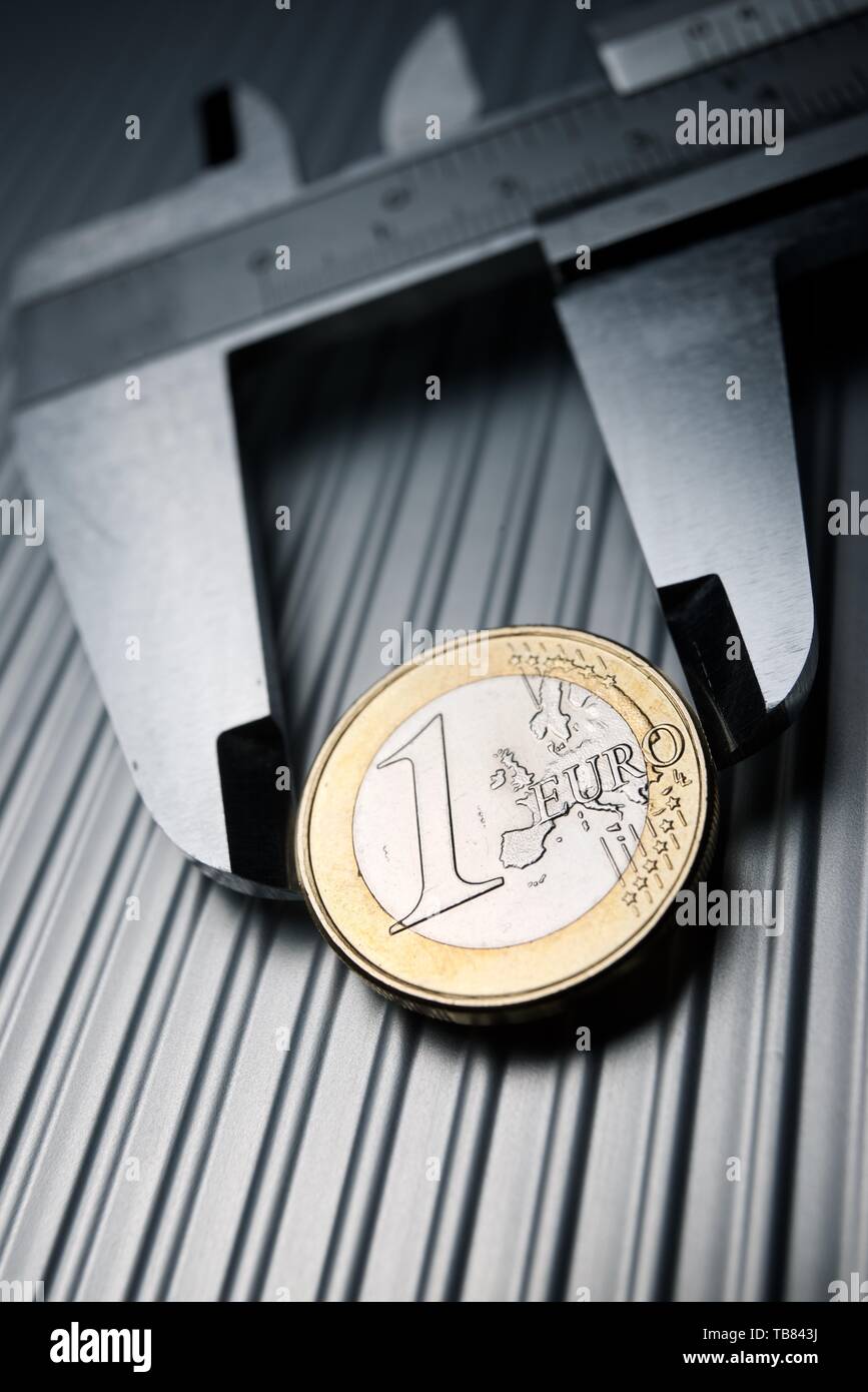 metal gauge measuring a one euro coin on a metal surface Stock Photo ...