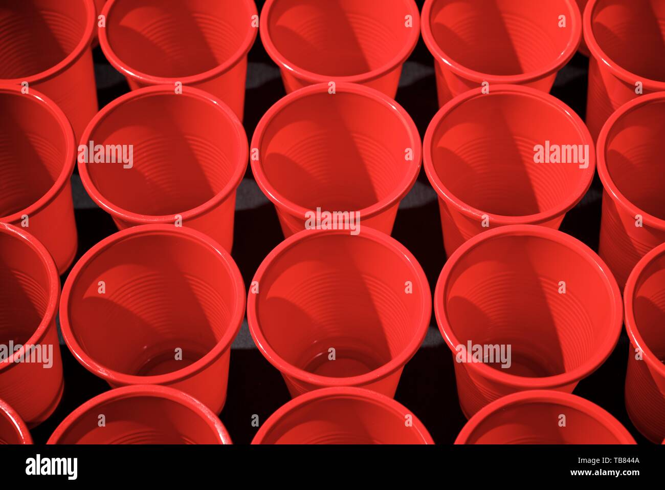 Drinking plastic cups on a black table Stock Photo - Alamy