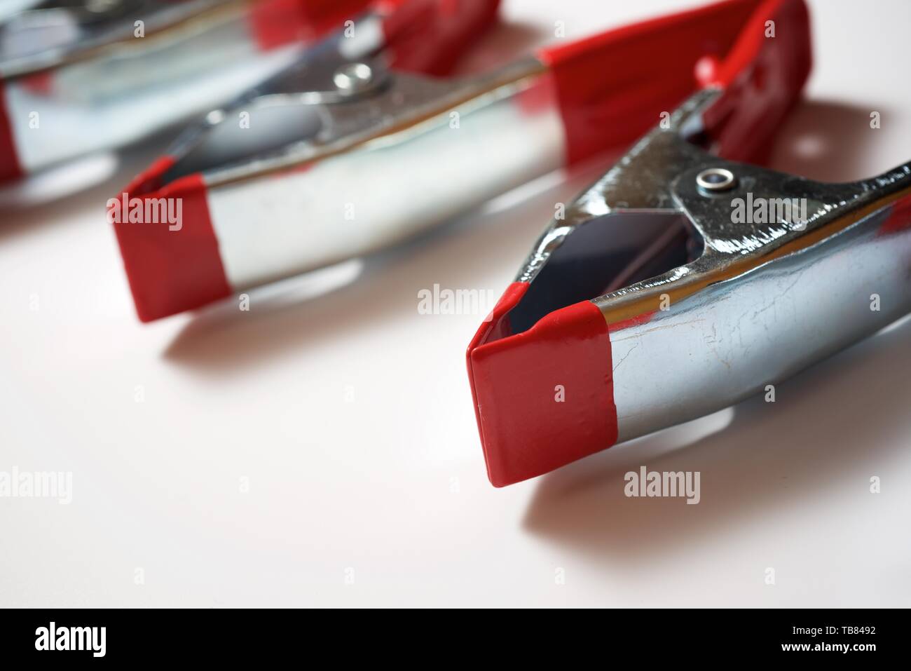 Clamps on a white table Stock Photo - Alamy