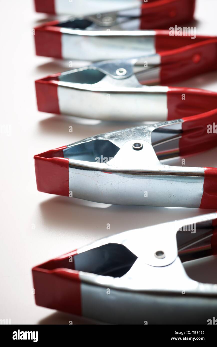 Clamps on a white table Stock Photo - Alamy