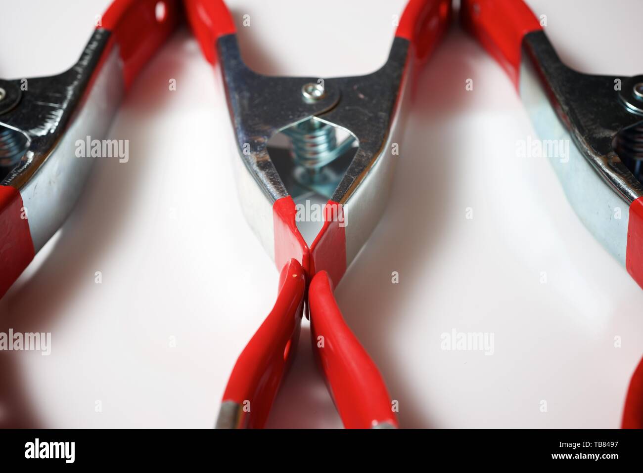 Clamps on a white table Stock Photo - Alamy