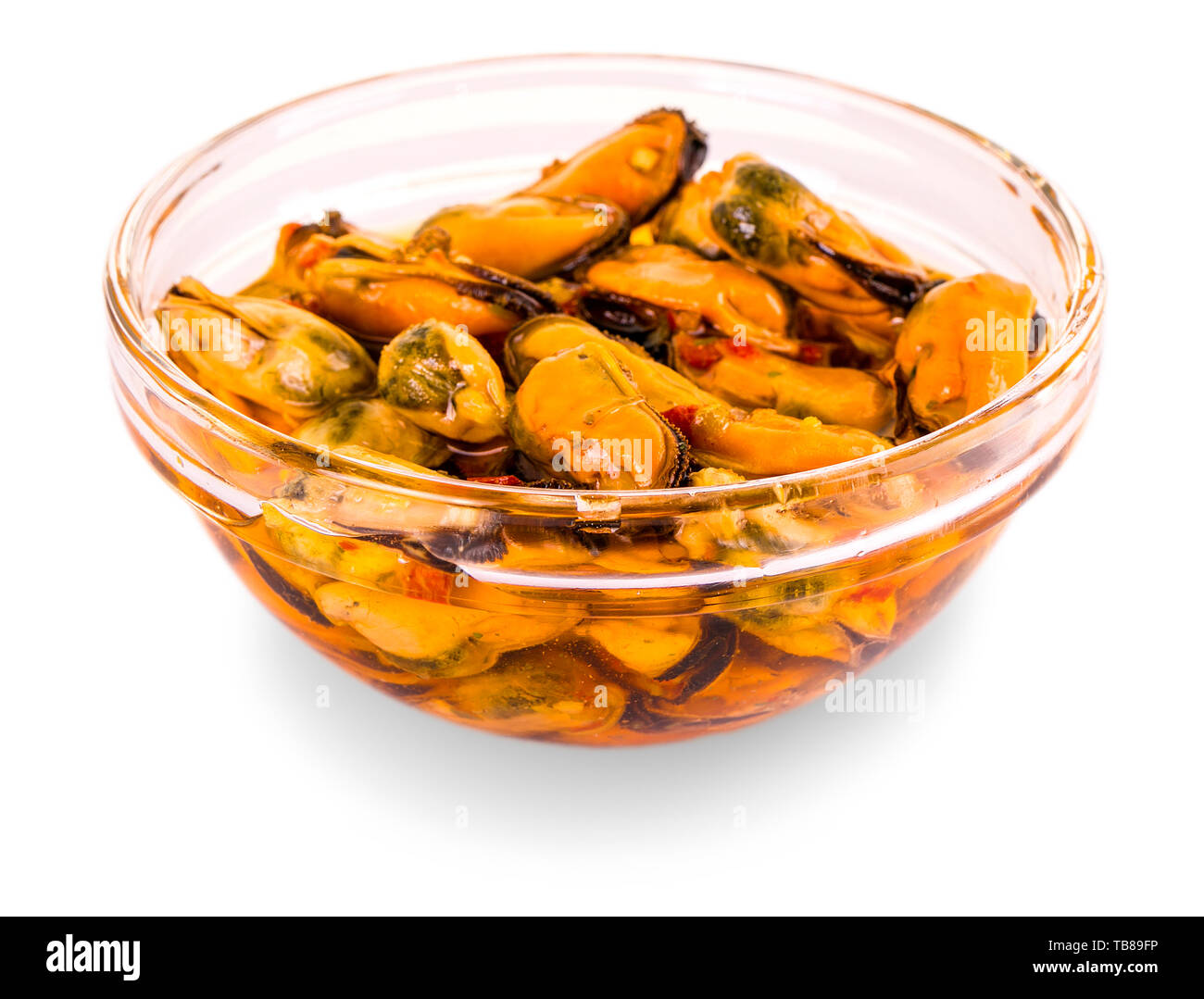 serving of pickled sea mussels in a glass bowl on a white background ...