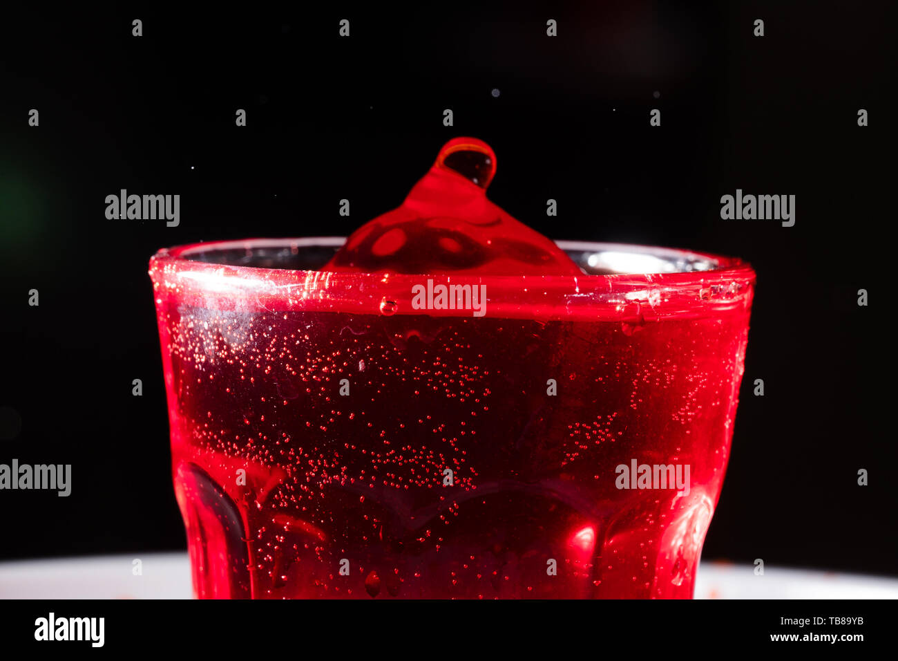 drops of red liquid in glass beaker Stock Photo - Alamy