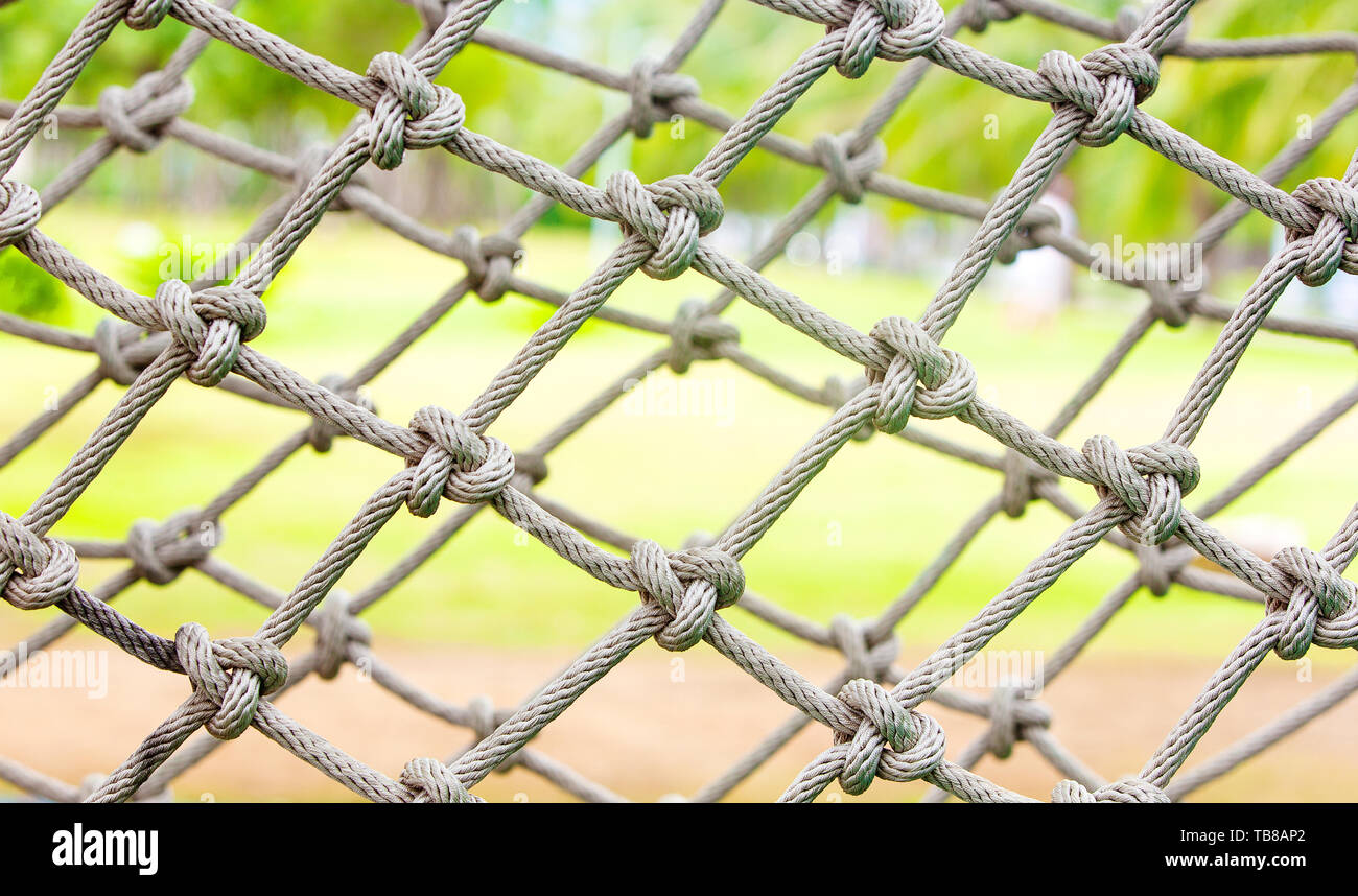 White rope tied in a knot for adventure Stock Photo - Alamy