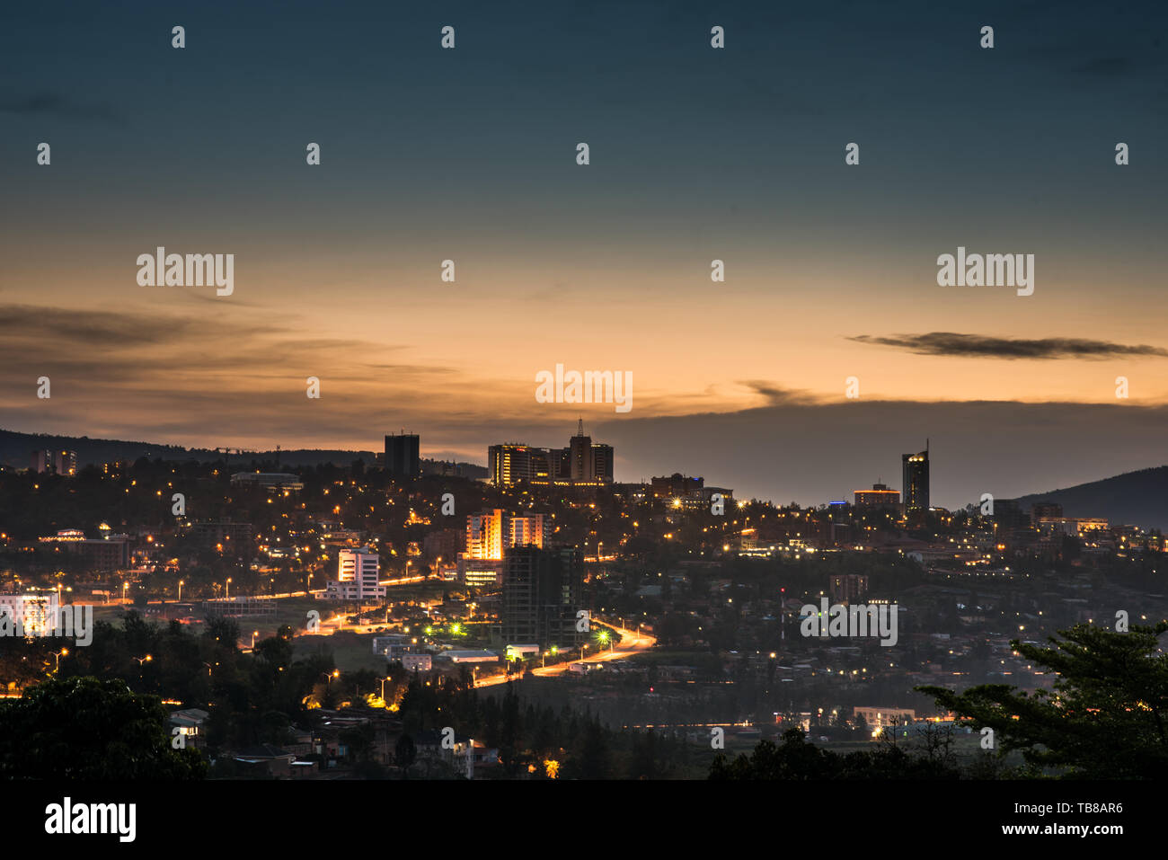 Kigali city centre skyline and surrounding areas lit up at dusk. Rwanda ...